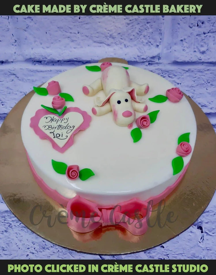 A cake for a dog love with a cute pup on top of cake with small flowers ...