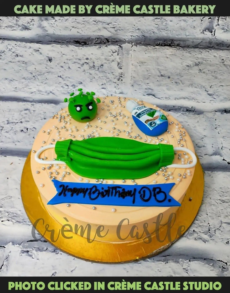 A corona theme cake with mask and virus on top along with the sanitizer ...